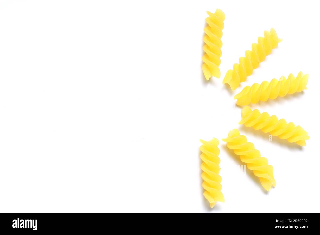 Uncooked fusilli pasta isolated on white background. Itallian spiral ...