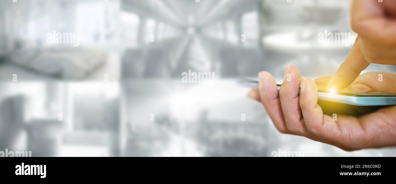 Remote work concept. A man's hand uses a smartphone to work or do his ...