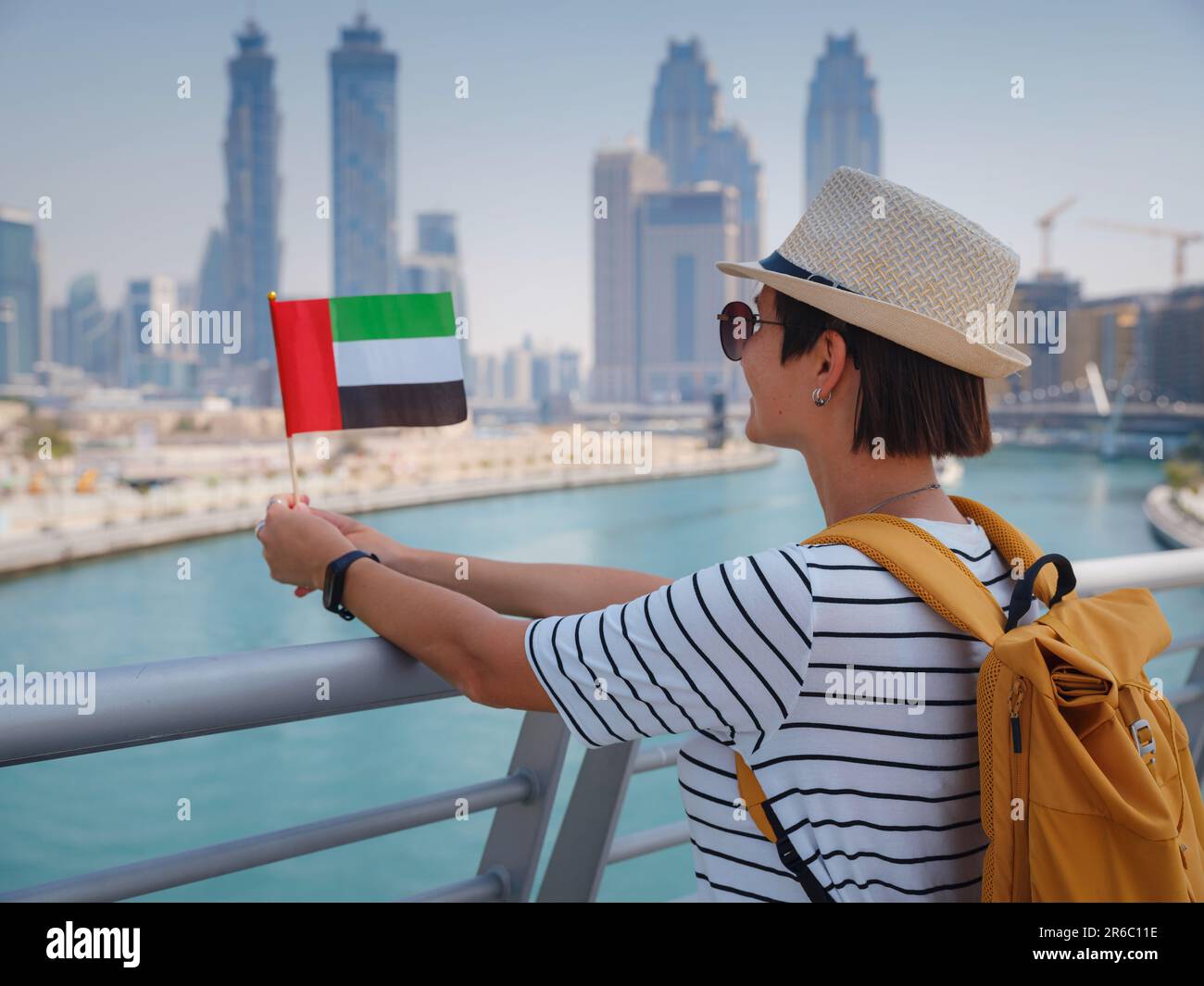 asian happy traveler woman with hat and yellow backpack with the flag ...