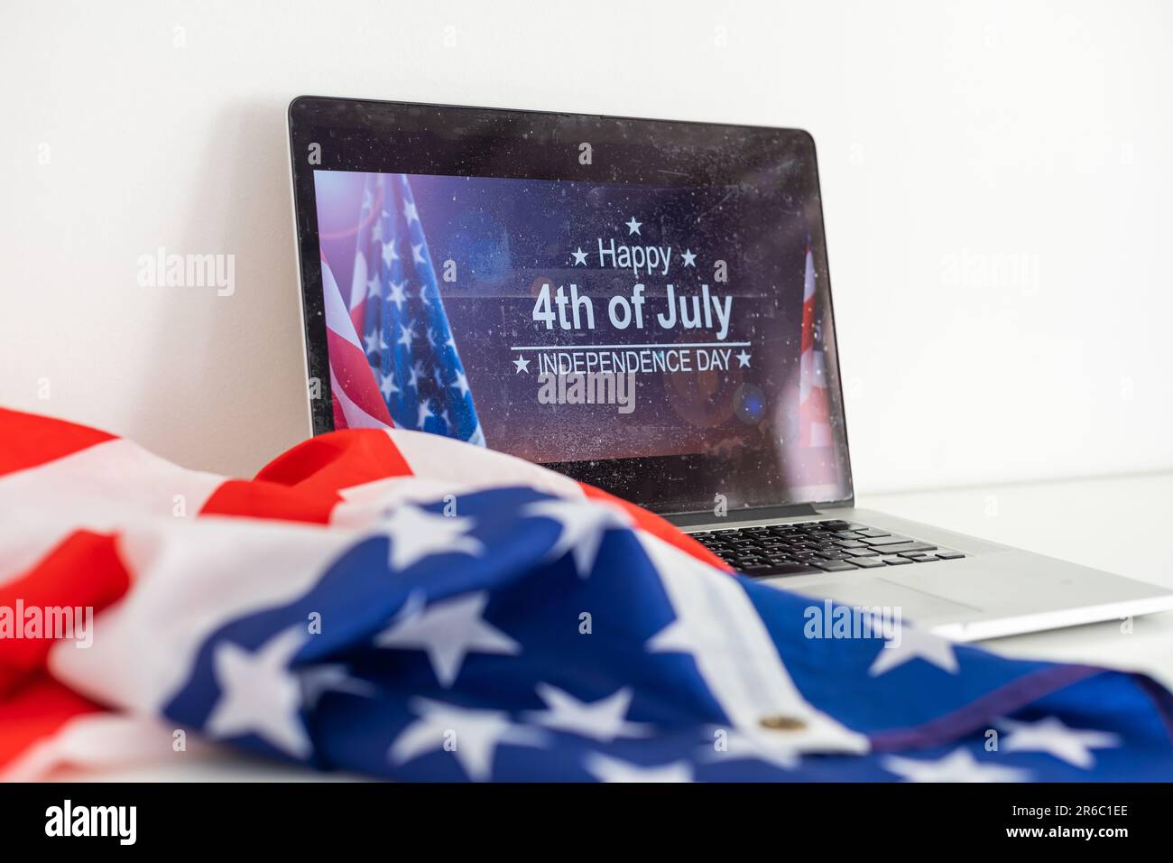 American flag on the desk and laptop screen. Fourth of July Concept ...