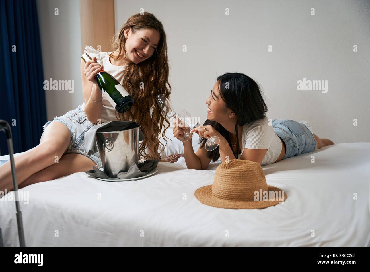 Two girls celebrating a trip in a hotel room Stock Photo - Alamy
