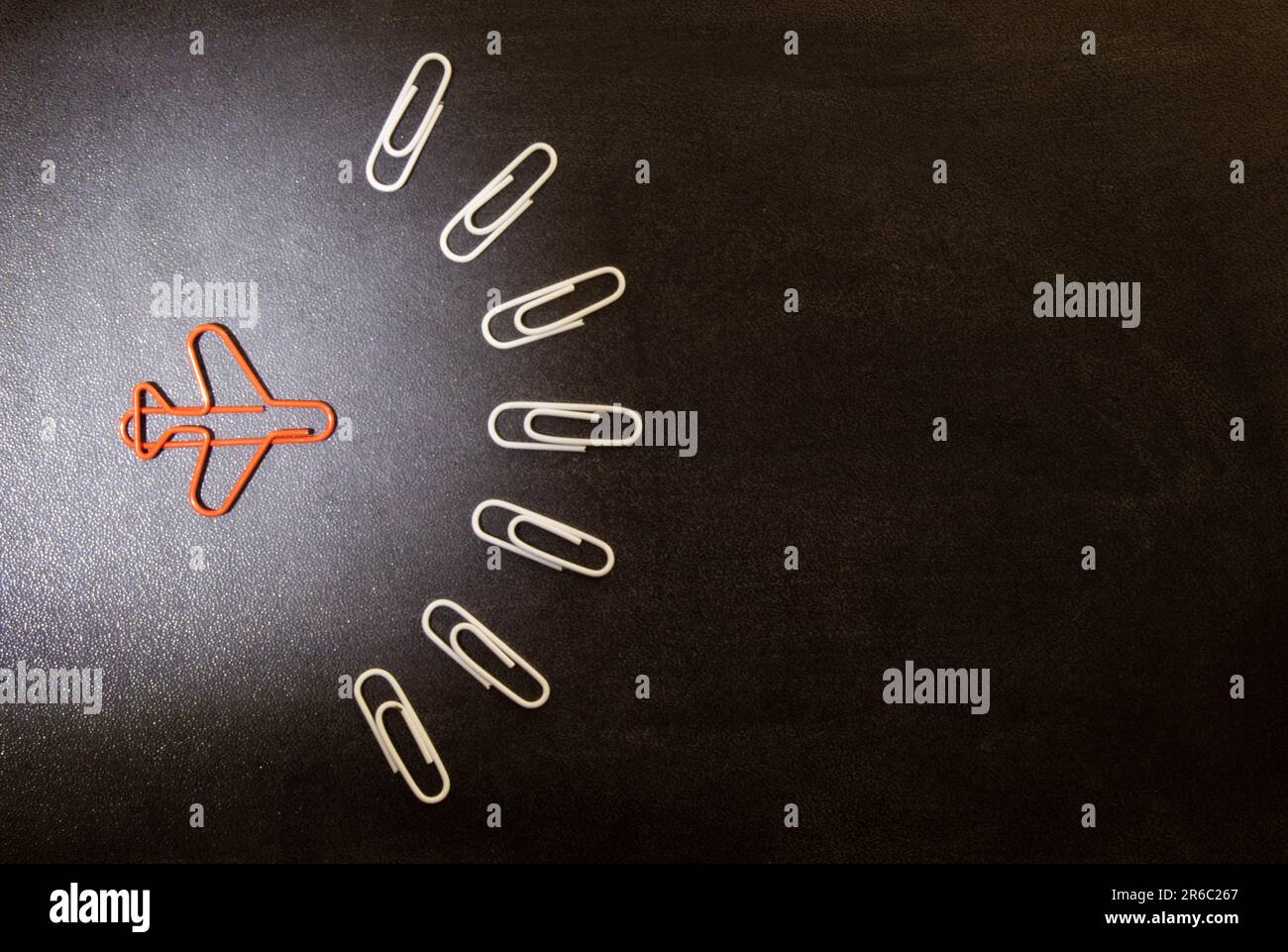 Concept image of unique thinking. Paper clips in the shape of airplane ...