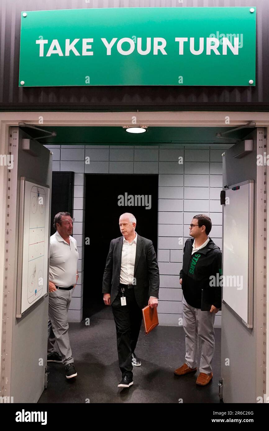 Dallas Stars manager Jim Nill, center, walks into the locker room to ...