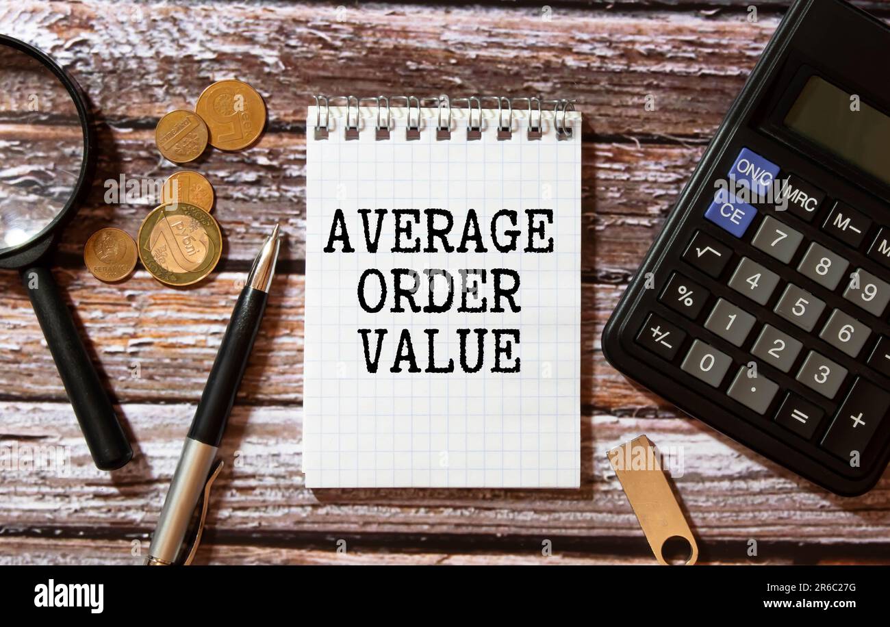 AVERAGE ORDER VALUE. Black marker on torn cardboard background Stock ...