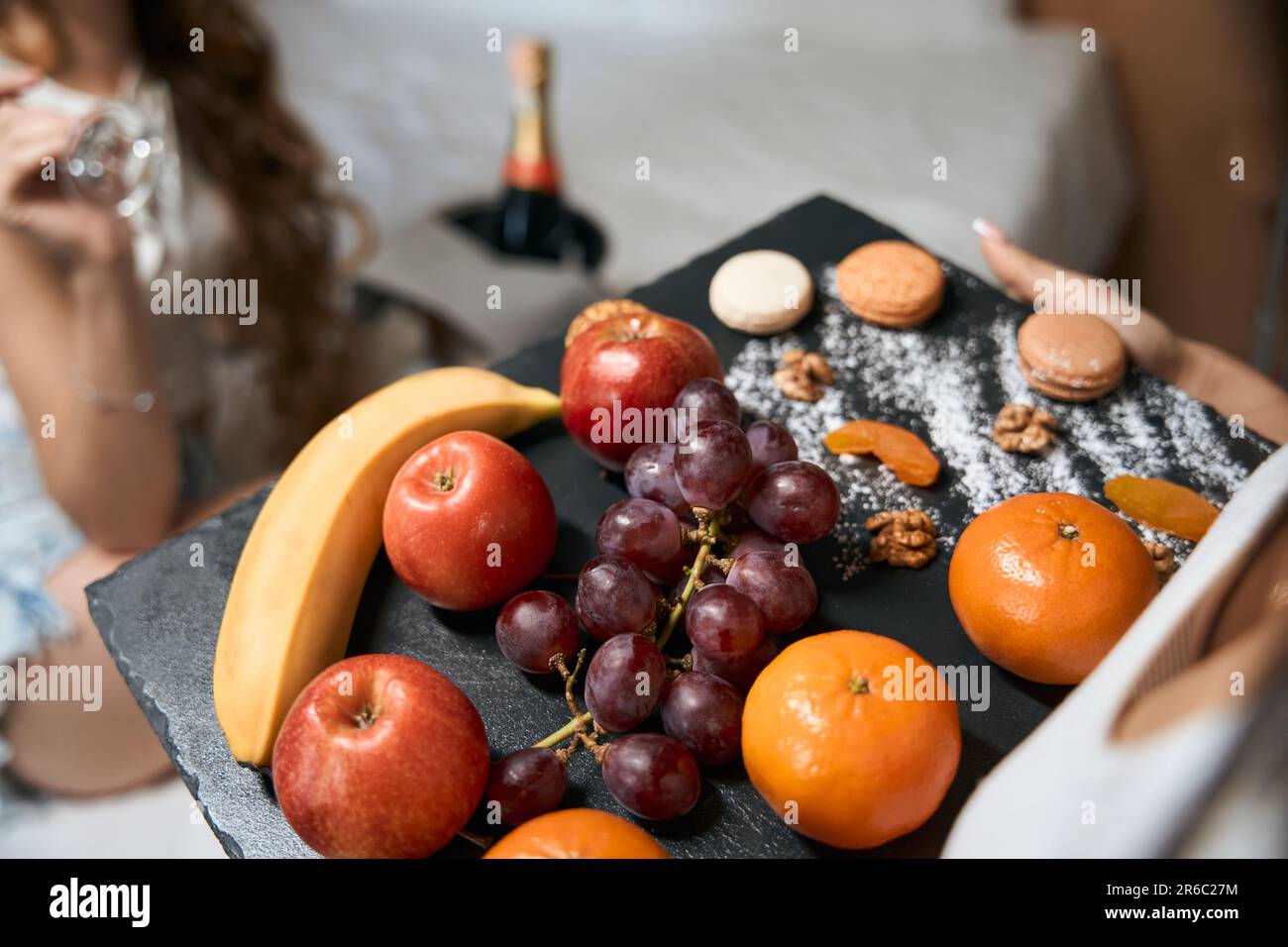 Fruits and sweets on the original tray Stock Photo - Alamy