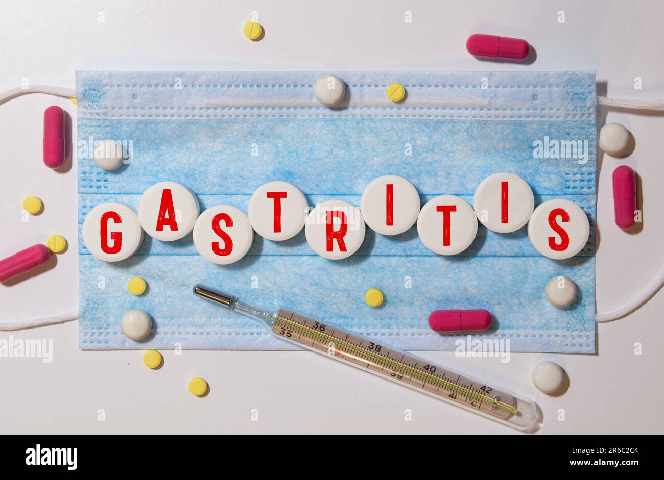 Gastritis - diagnosis written on a white piece of paper. Syringe and ...