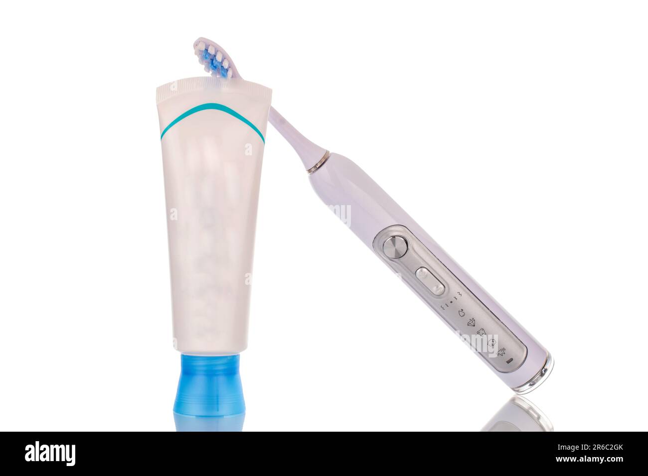 One plastic tube of toothpaste and one electric dental shield, macro ...