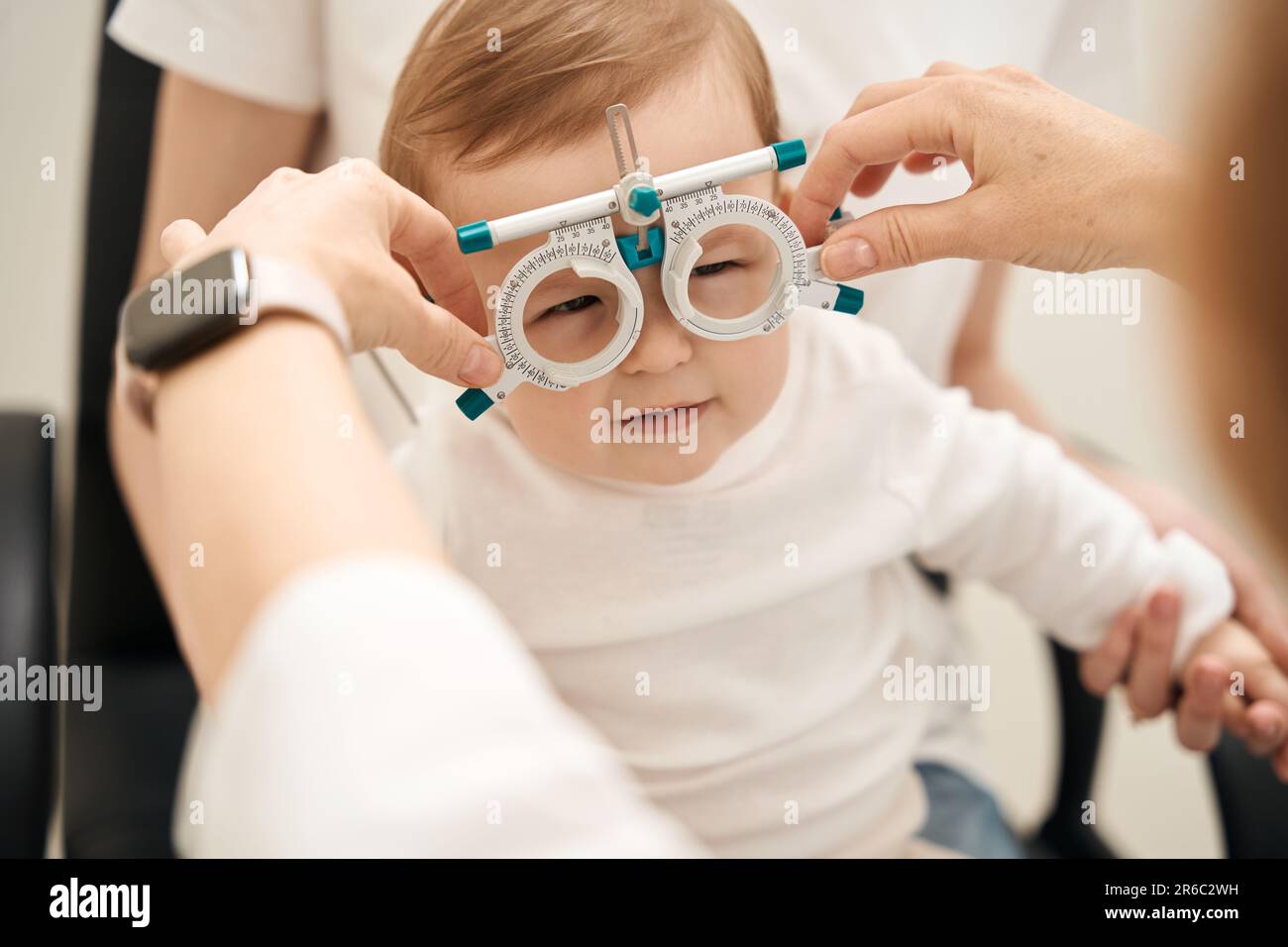 Pediatric eye doctor preparing child for visual acuity test Stock Photo ...