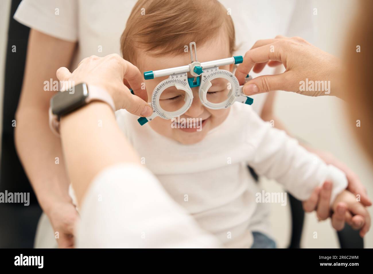 Eye specialist preparing little patient for visual acuity test Stock ...