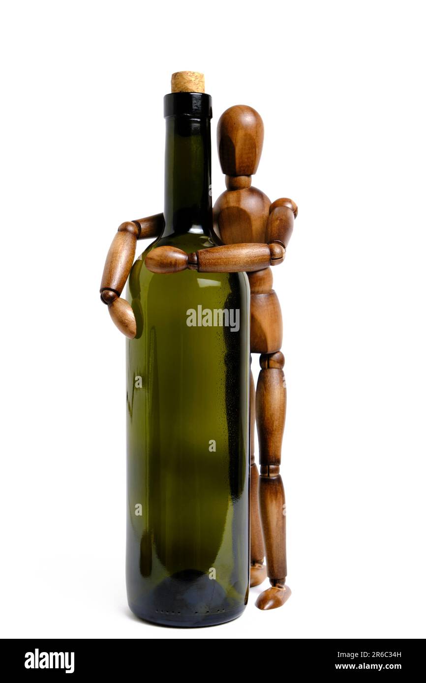 Standing wooden mannequin hugs an empty bottle of wine.Concept of ...