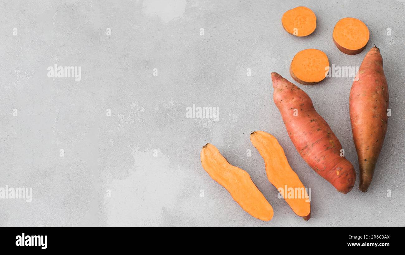 Raw sweet potatoes whole and cut. Orange kumara, sweet potato ...