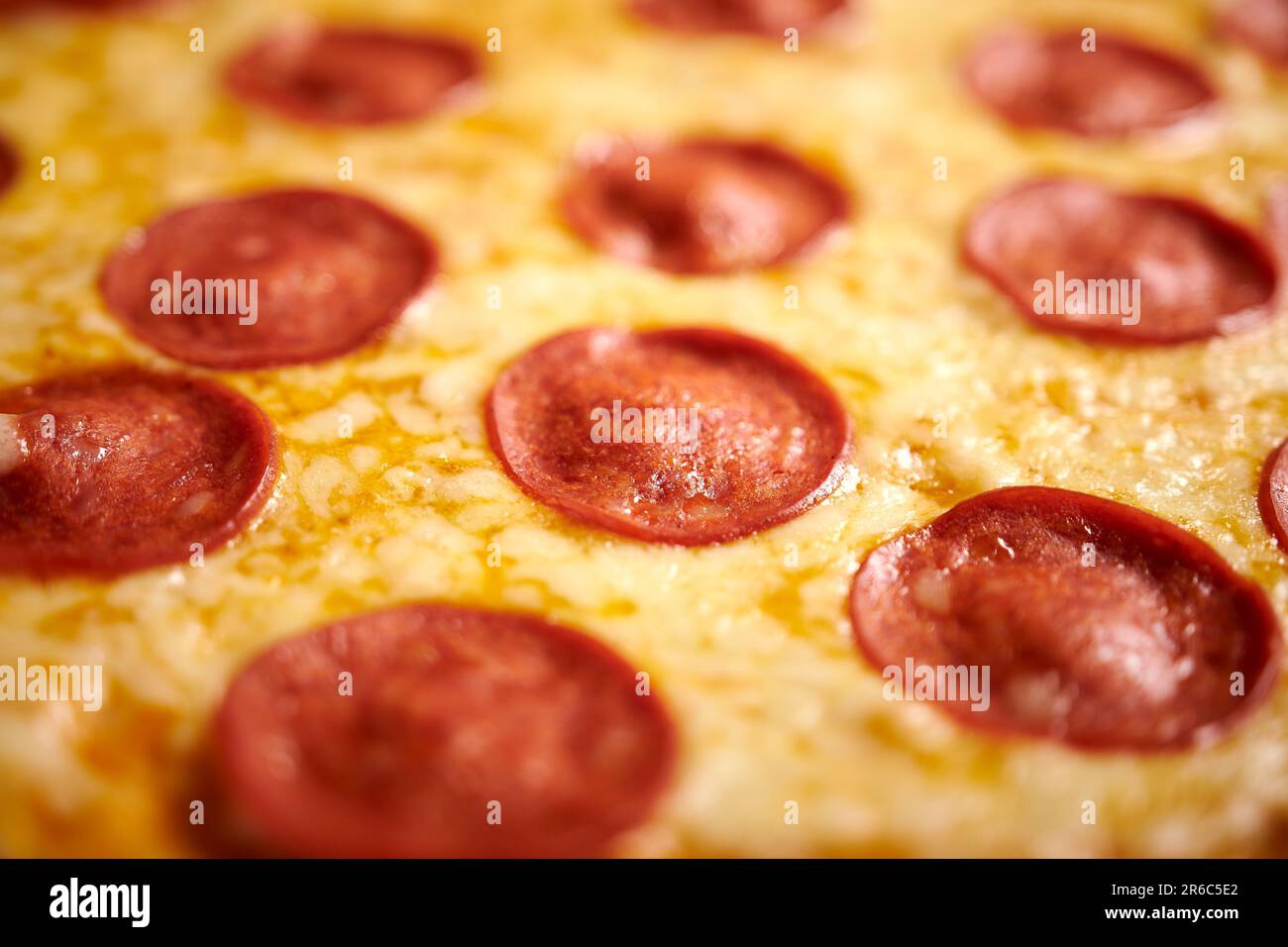A freshly-made pizza with a topping of pepperoni, cheese and other ...