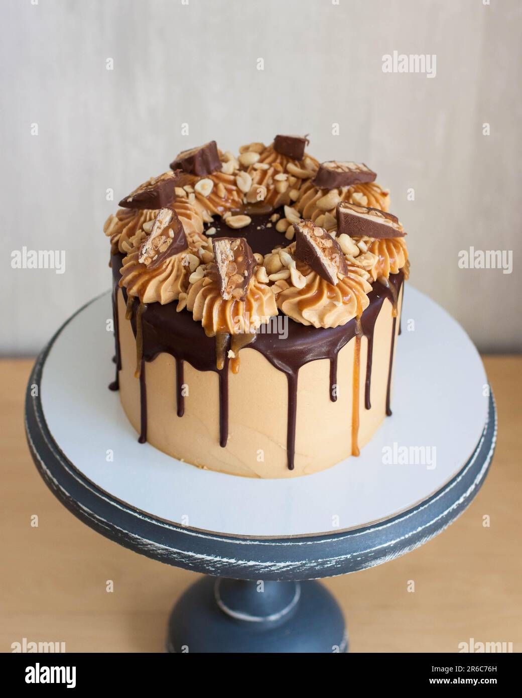 Snickers cake with peanut butter cream, melted chocolate, candy bars ...
