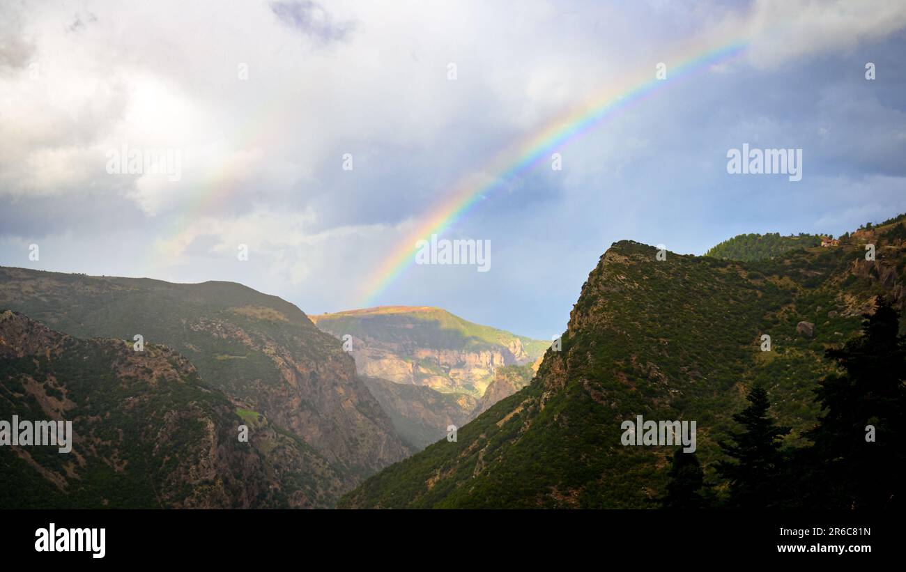 Rainbow arches over mountain hi-res stock photography and images - Alamy