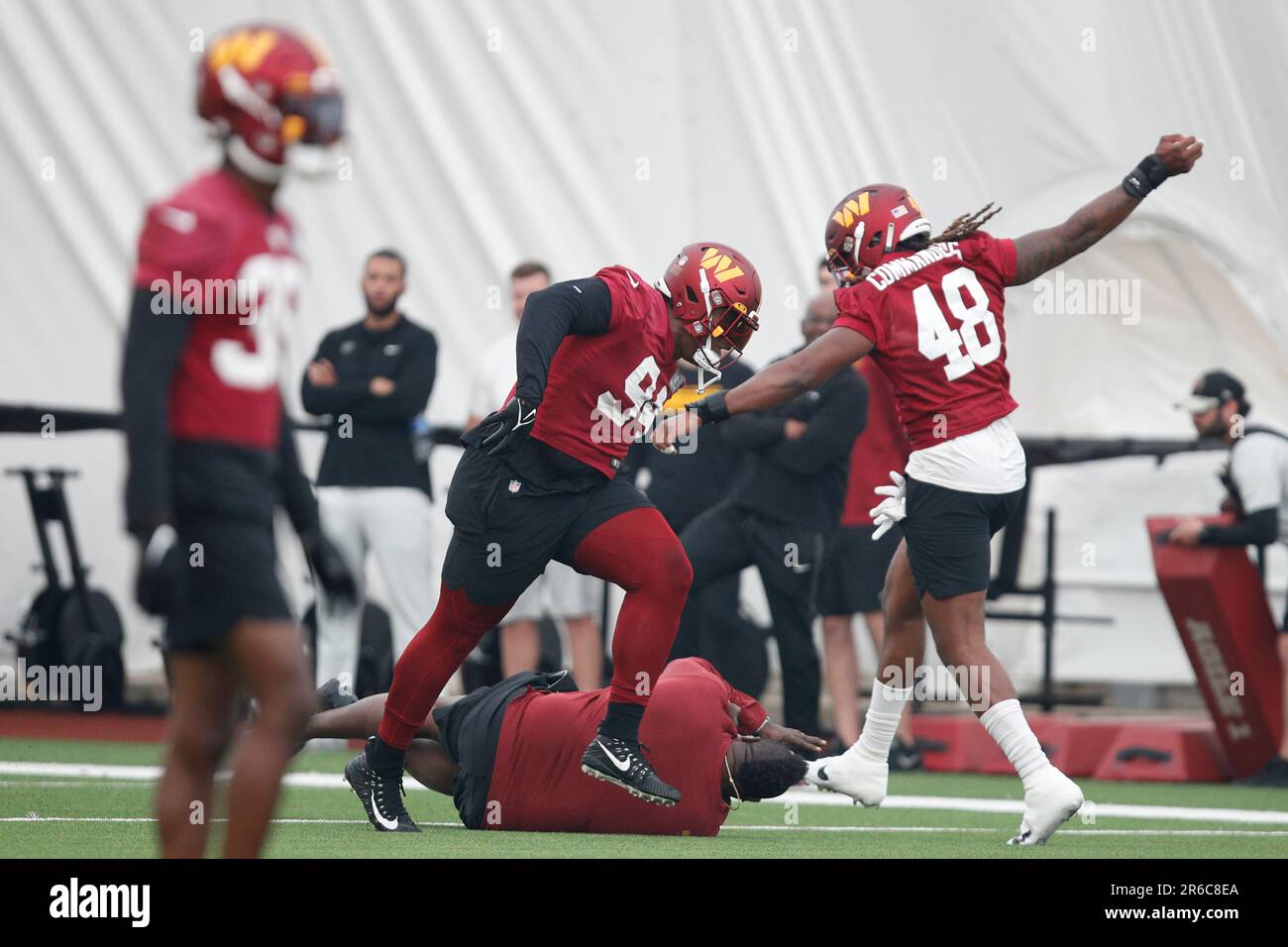 Pro Football Hall of Famer Warren Sapp, center, falls as he conducts ...