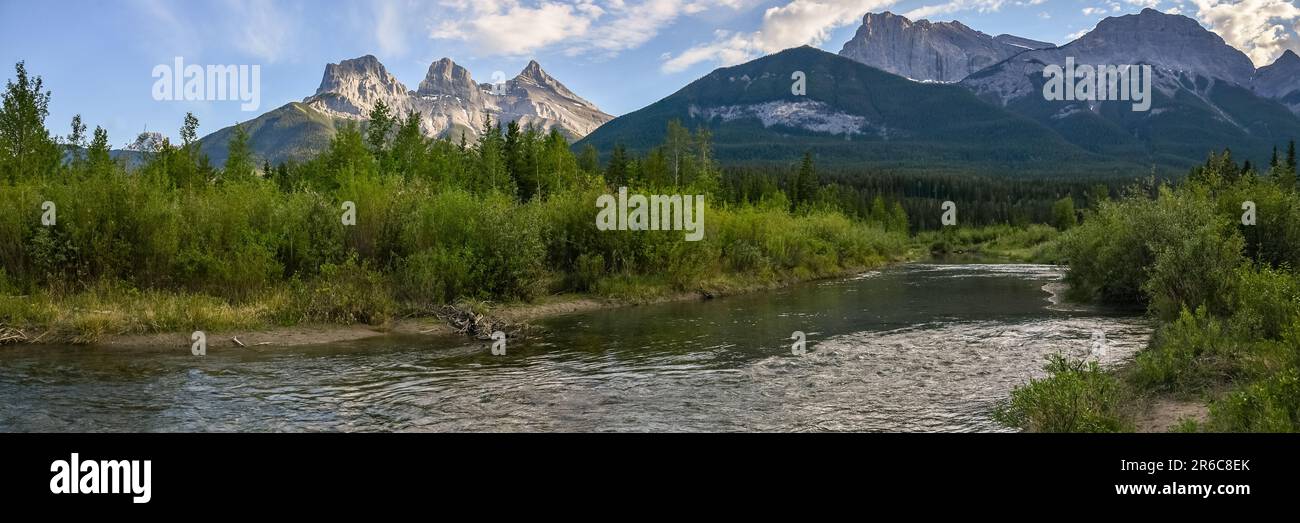 Mountain peaks reflecting in the calm water below at Three Sisters in ...