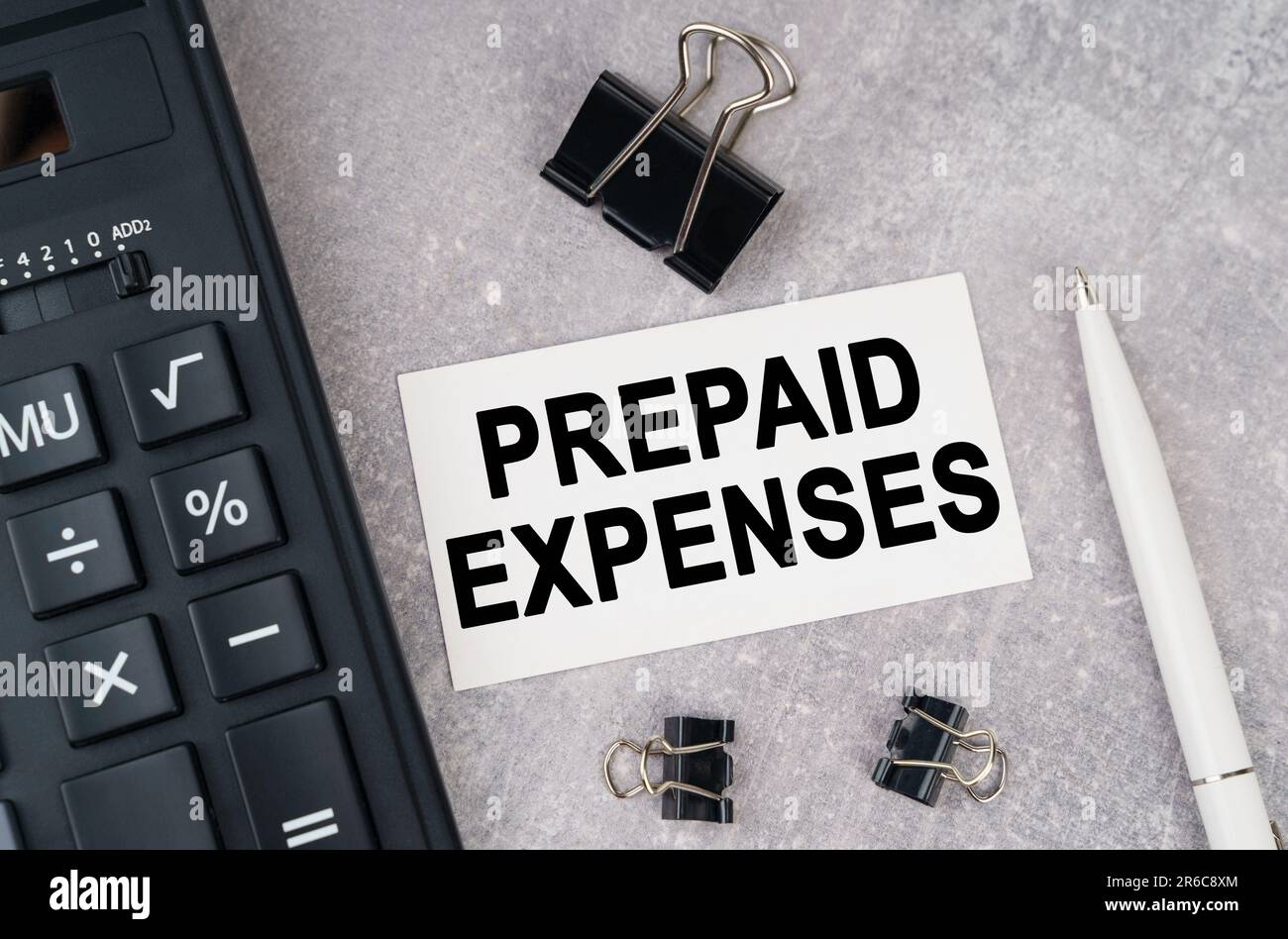 Business concept. On a gray surface lies a calculator, a pen and a ...