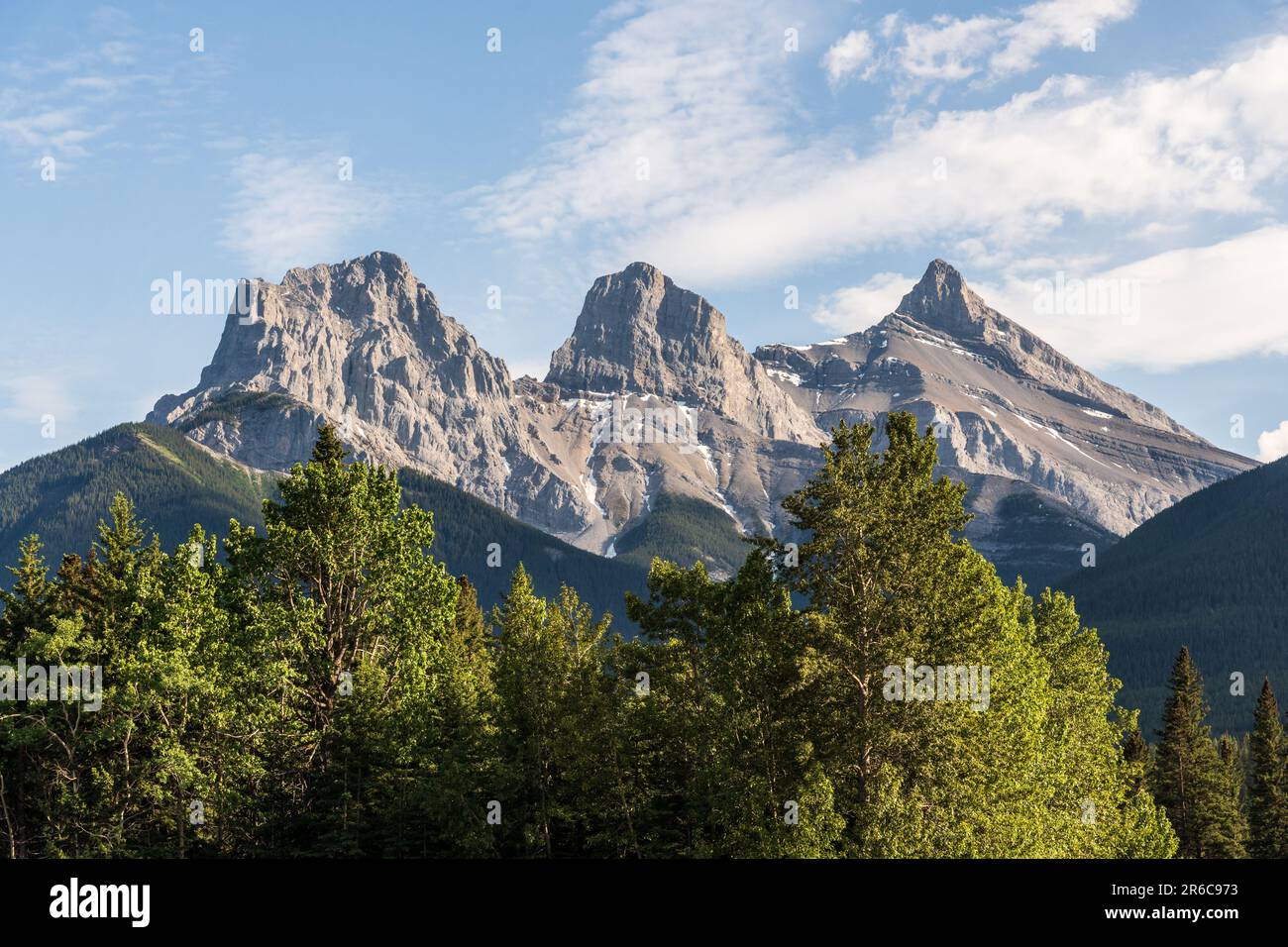 Mountain peaks reflecting in the calm water below at Three Sisters in ...
