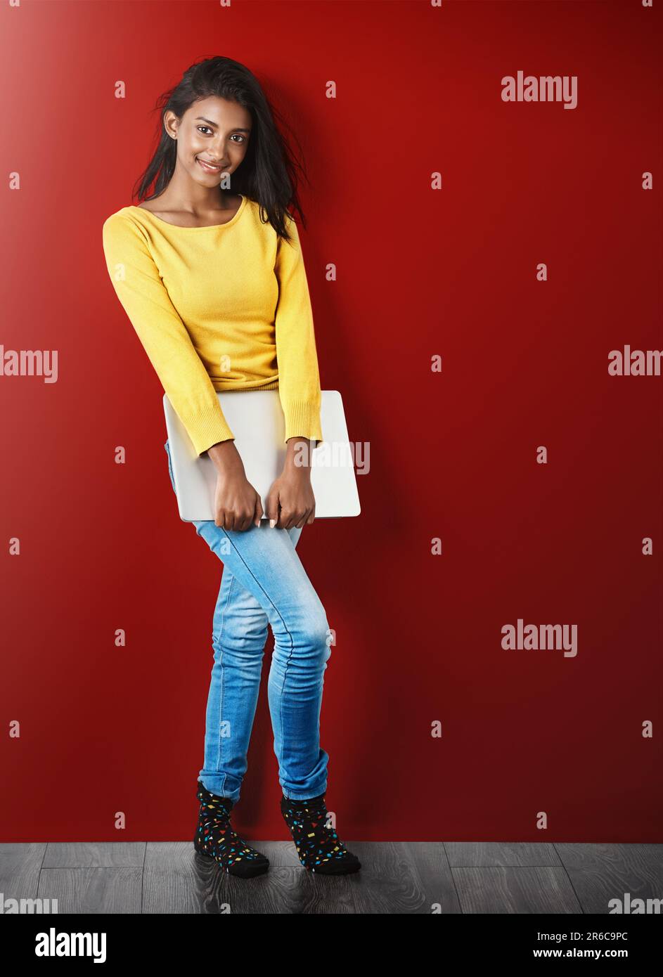 Student woman, portrait and laptop by wall with smile for learning ...