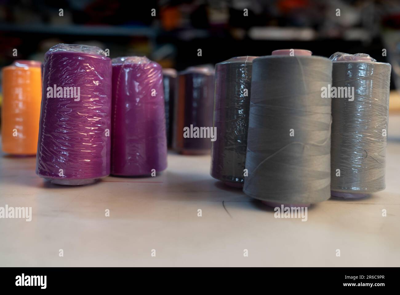 Selective focus of sewing thread. Some sewing threads have packaging on ...