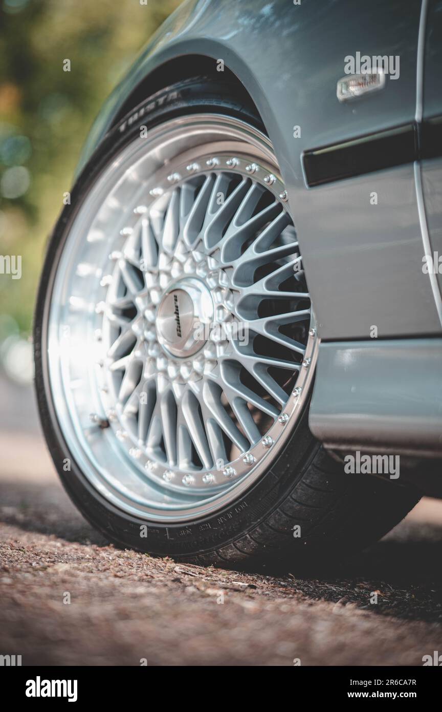 Two car wheels parked side by side on a city street Stock Photo - Alamy