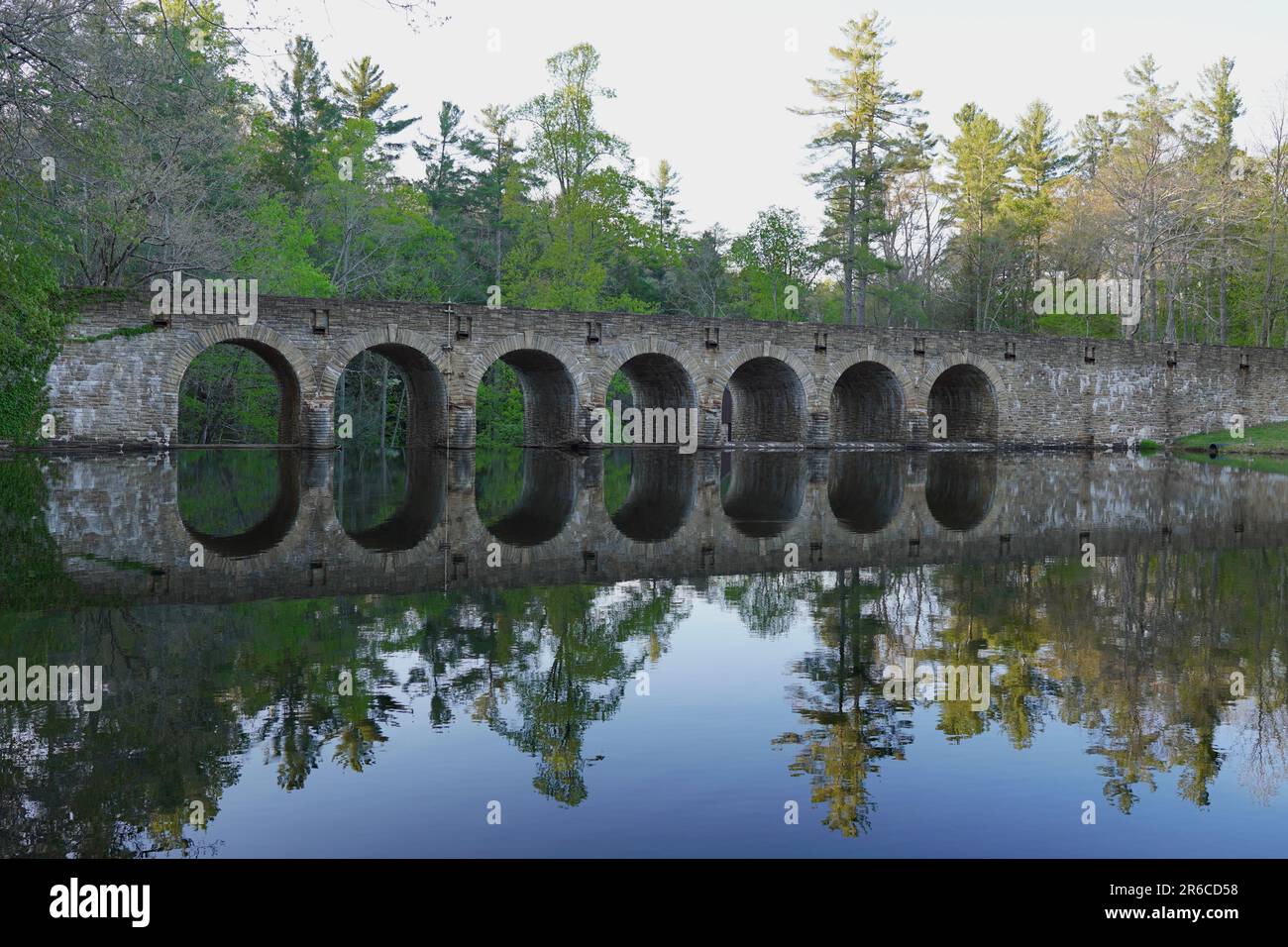 Historic stone bridge reflecting in lake in Cumberland Mountain State ...