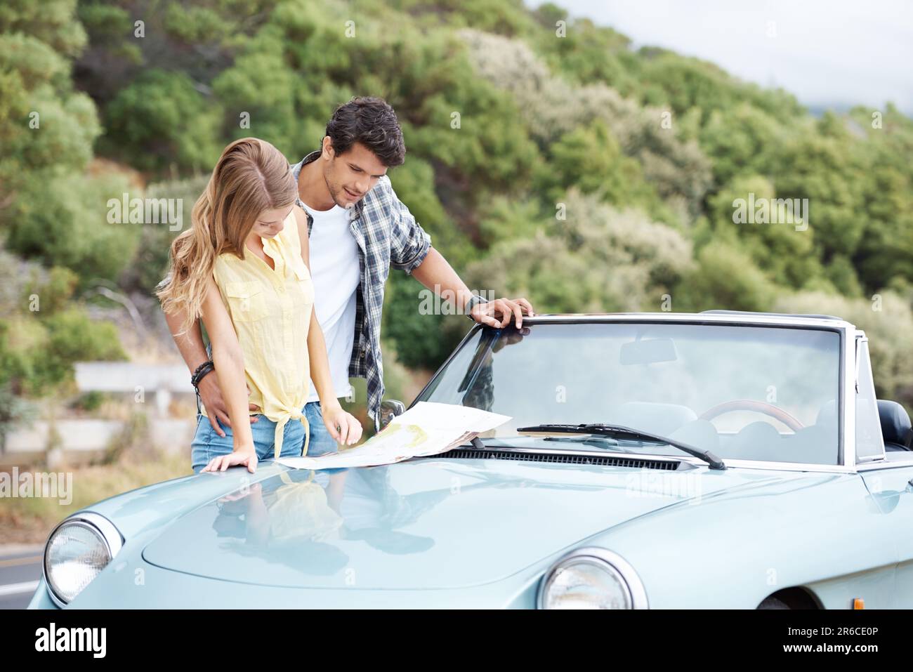 Which route should we take next. A cute young couple checking over a ...