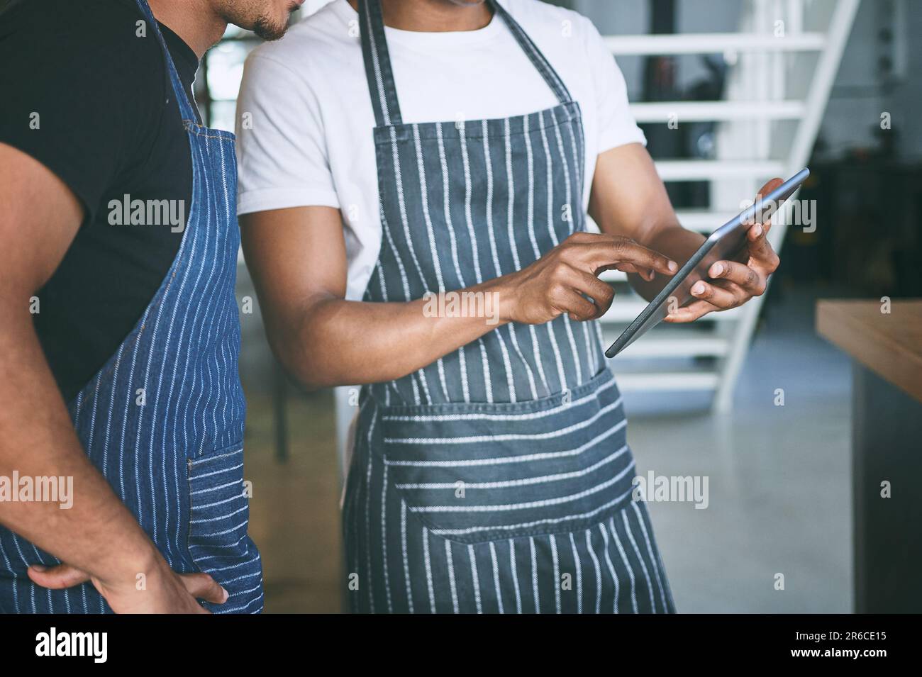 Finding new customers is just a tap away. two unrecognisable men using ...