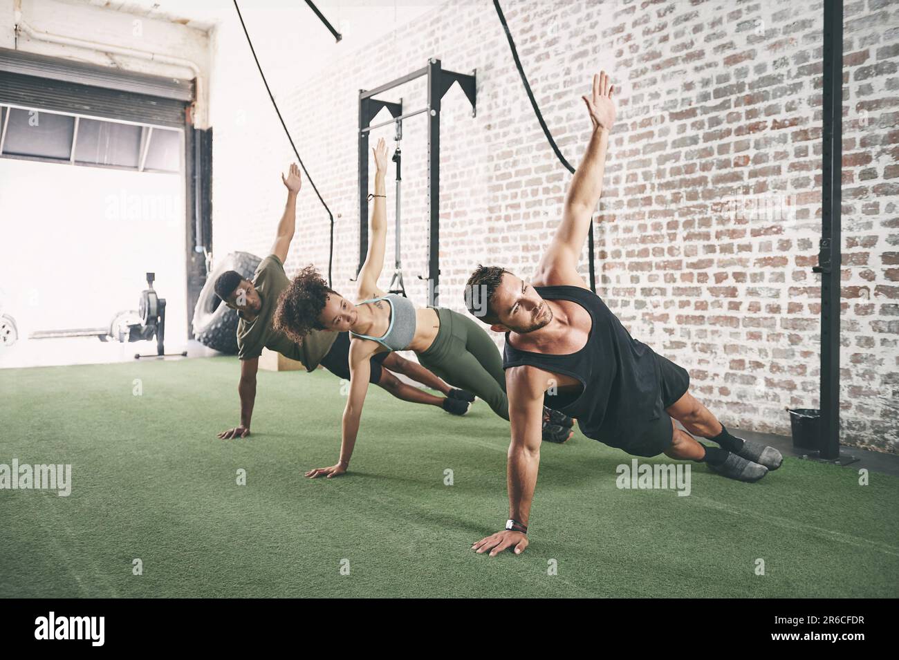 Building strength from side to side. a fitness group doing the side ...
