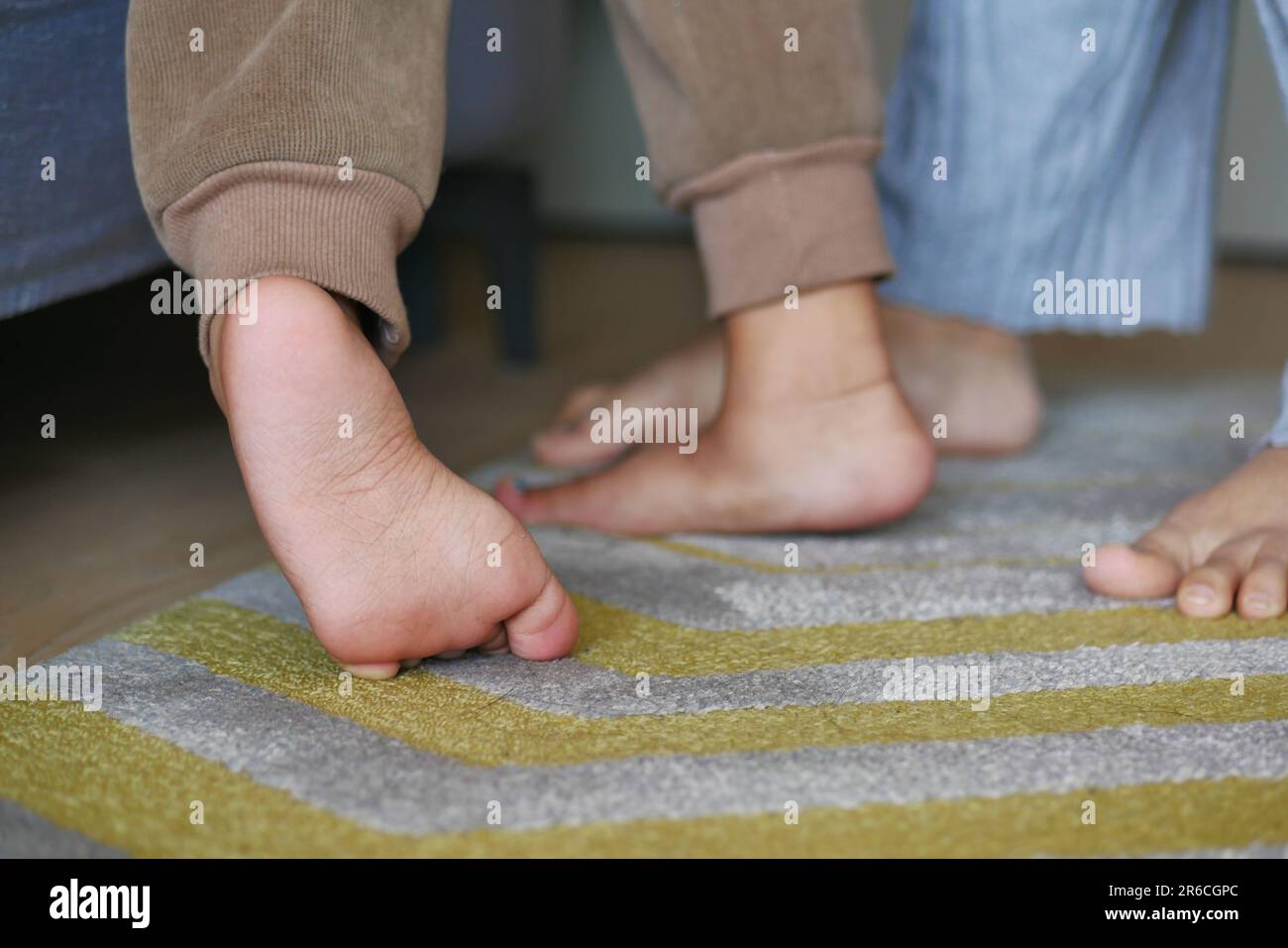 low angle view of A child walking on tiptoes Stock Photo - Alamy
