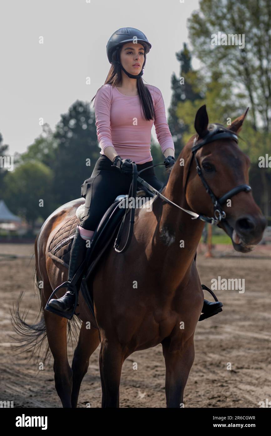 Girl riding a running horse with helmet hi-res stock photography and ...