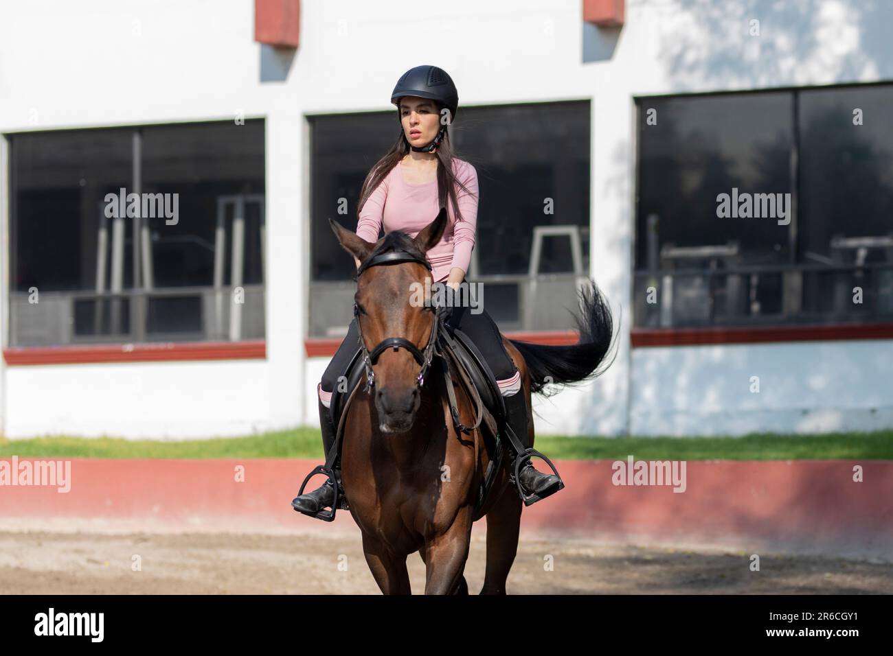 Young mexican woman riding a horse in her ranch Stock Photo - Alamy