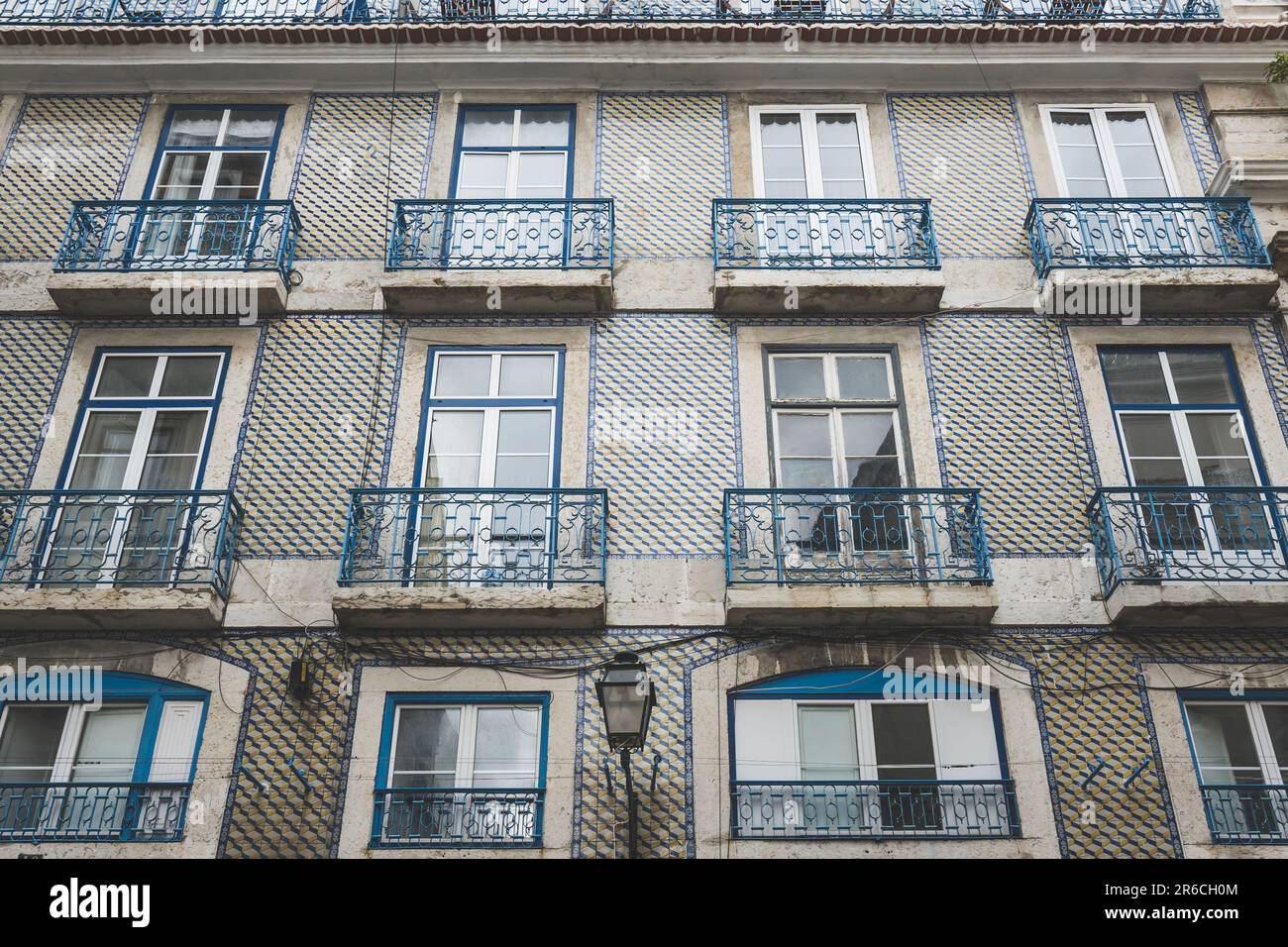 Classic apartment building with balconies and shutters in Lisbon ...