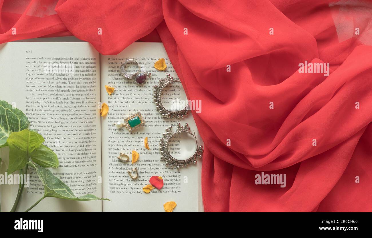 A selection of jewelry pieces is laid out on an open book, with the ...