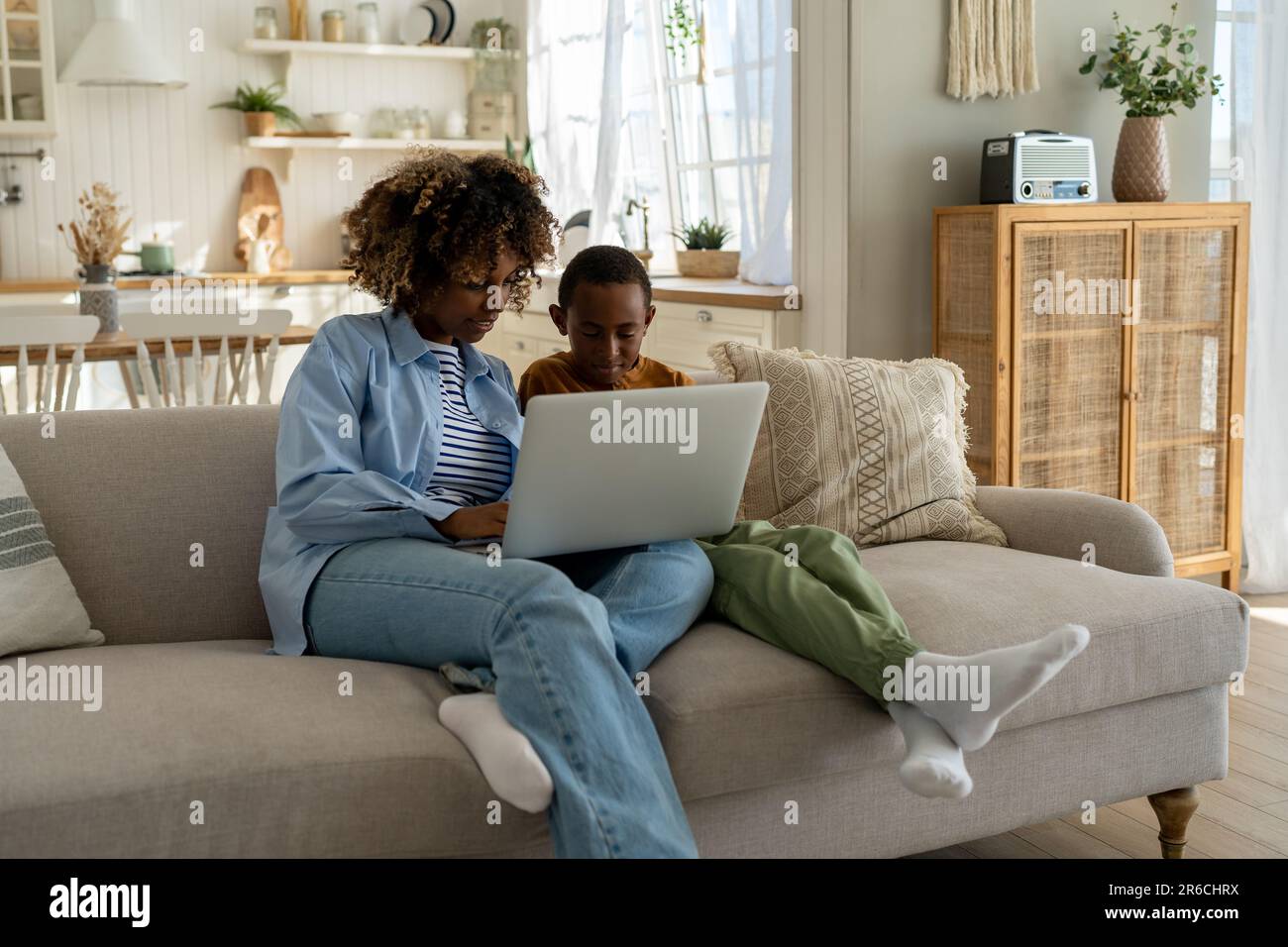 Happy african american family, mother and child looking at computer ...