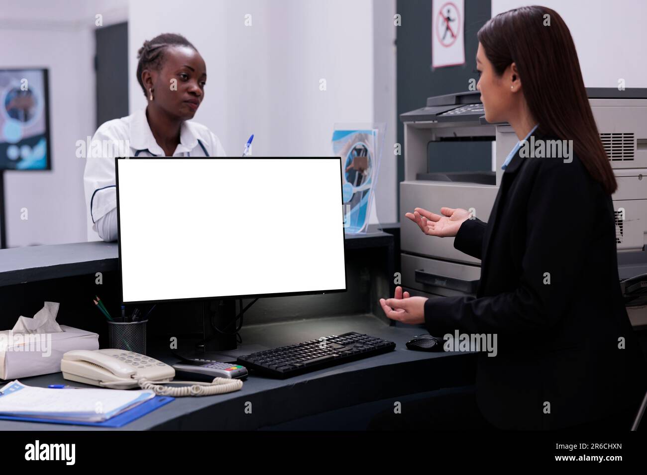 Reception worker manages patient records and schedules appointments ...