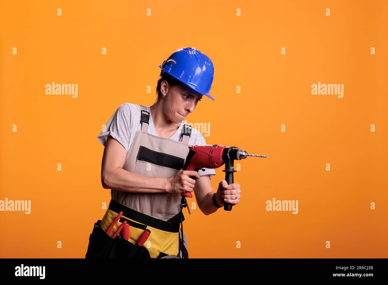 Female industrial engineer holding drilling gun in new interior ...
