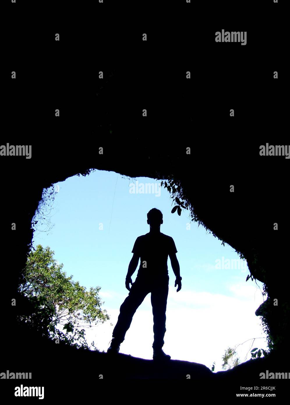 Captivating inside-out view of a cave with the striking silhouette of a ...