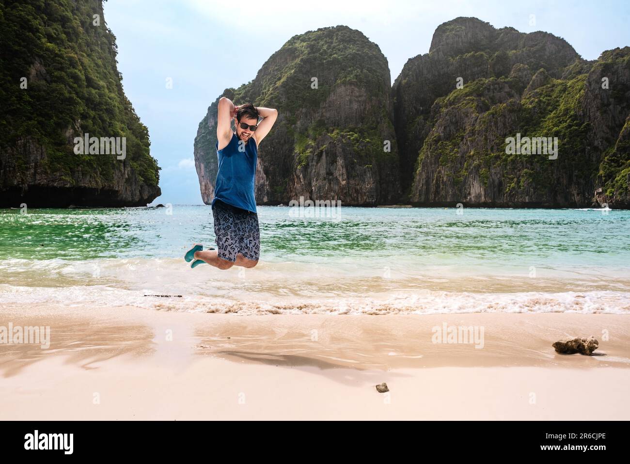 Man jumping on the beach at Maya Bay, Phi Phi Islands, Thailand Stock ...