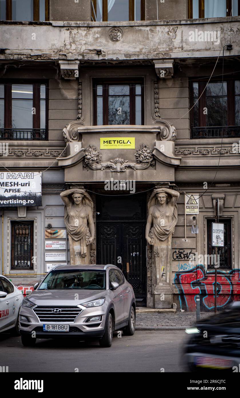 The entrance to a heritage building in Bucharest is flanked by two ...