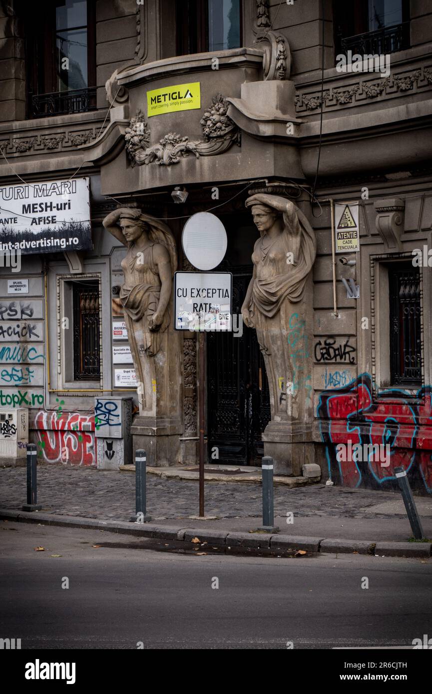 The entrance to a heritage building in Bucharest is flanked by two ...