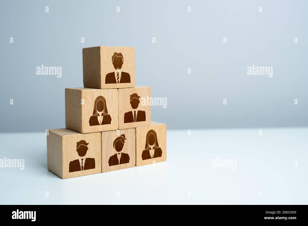 Pyramid of blocks with workers. Putting people in their places ...