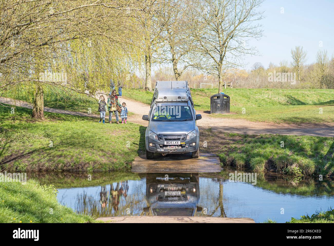 4x4 Council vehicle driving through a water ford in a country park ...