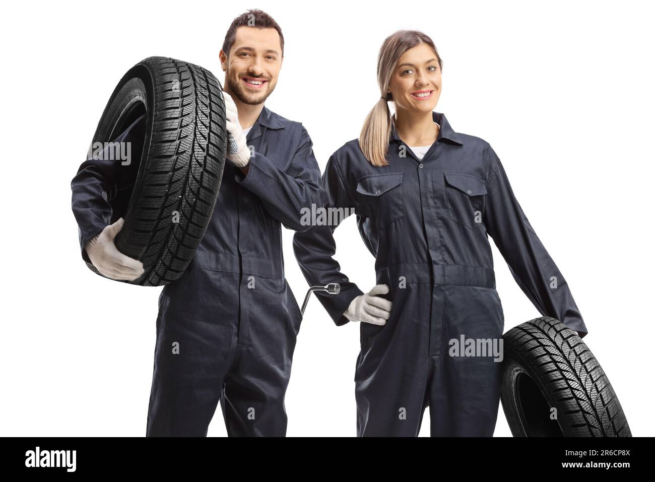 Male and female car mechanic workers carrying tires isolated on white ...