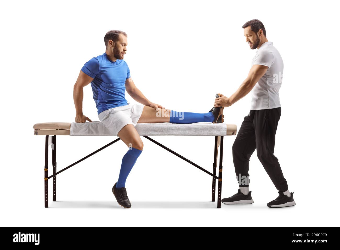 Physical therapist treating a football player isolated on white ...