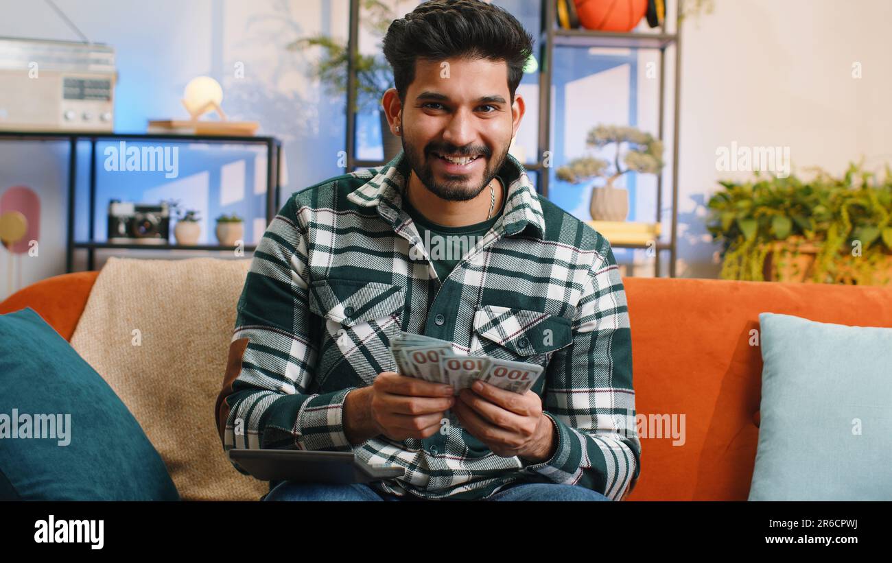 Planning budget. Rich happy indian man counting money cash use ...