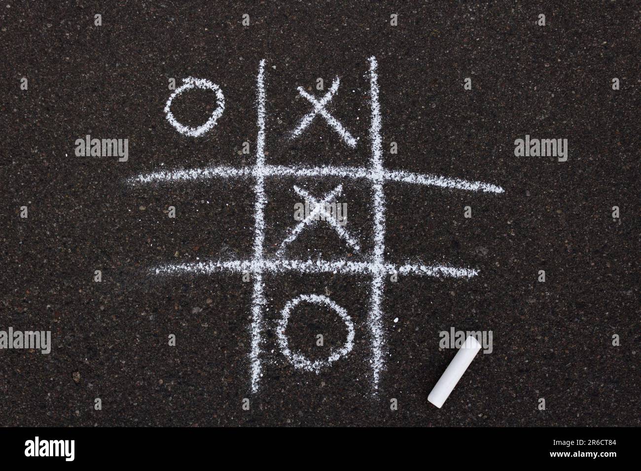 Drawing on the pavement drawn with white chalk. Tic-tac-toe game Stock ...