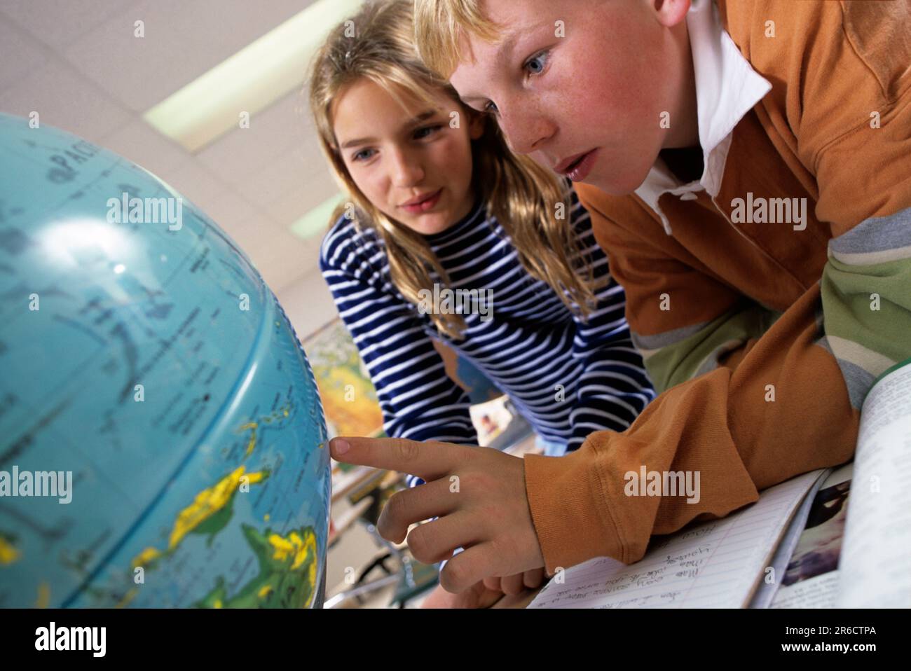 pupil using a world globe to complete a project in school Stock Photo ...