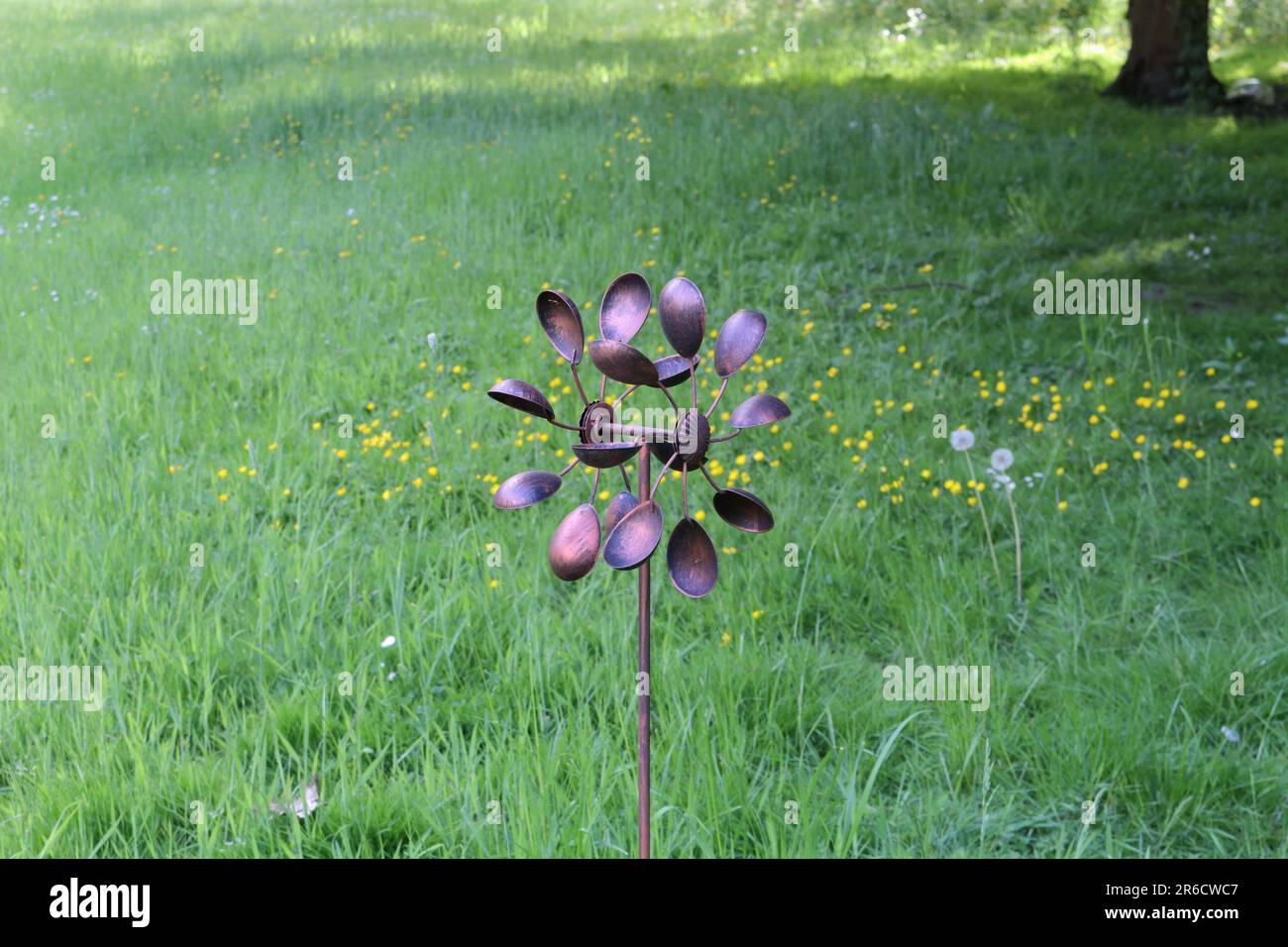 A wind powered rotating garden feature sculpture in a cemetery ...