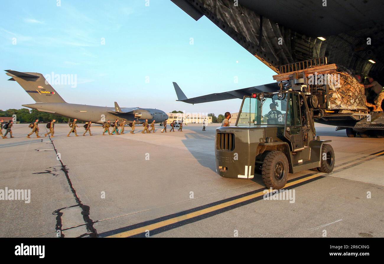 Air National Guard personnel board a C-17 Globemaster III of the 144th ...
